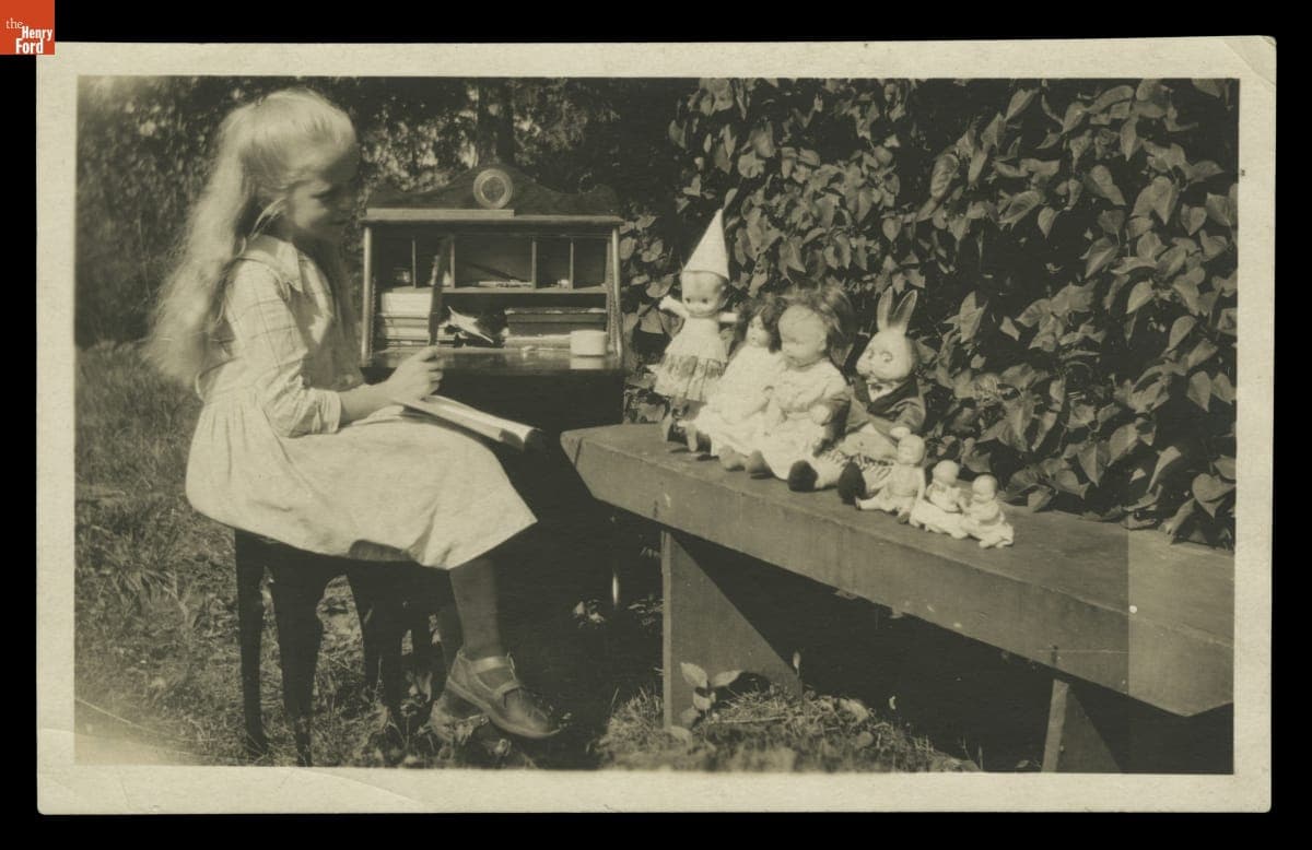 Young Girl Playing School with Dolls and a Peter Rabbit Stuffed Toy ...